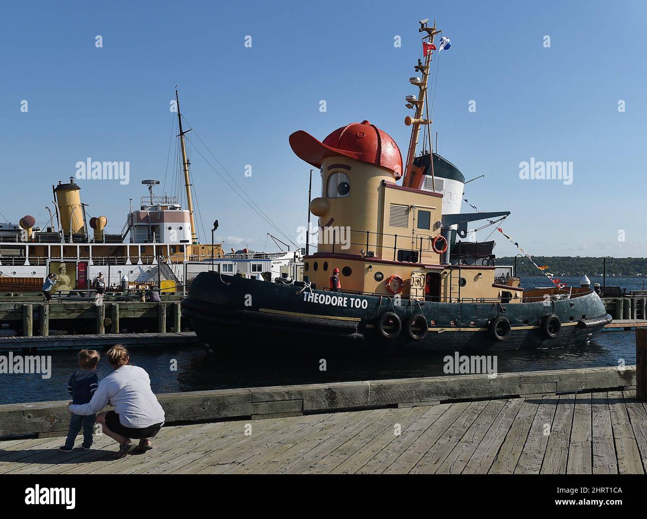 A young boy looks on as the tugboat Theodore Too, a 20-metre replica of ...