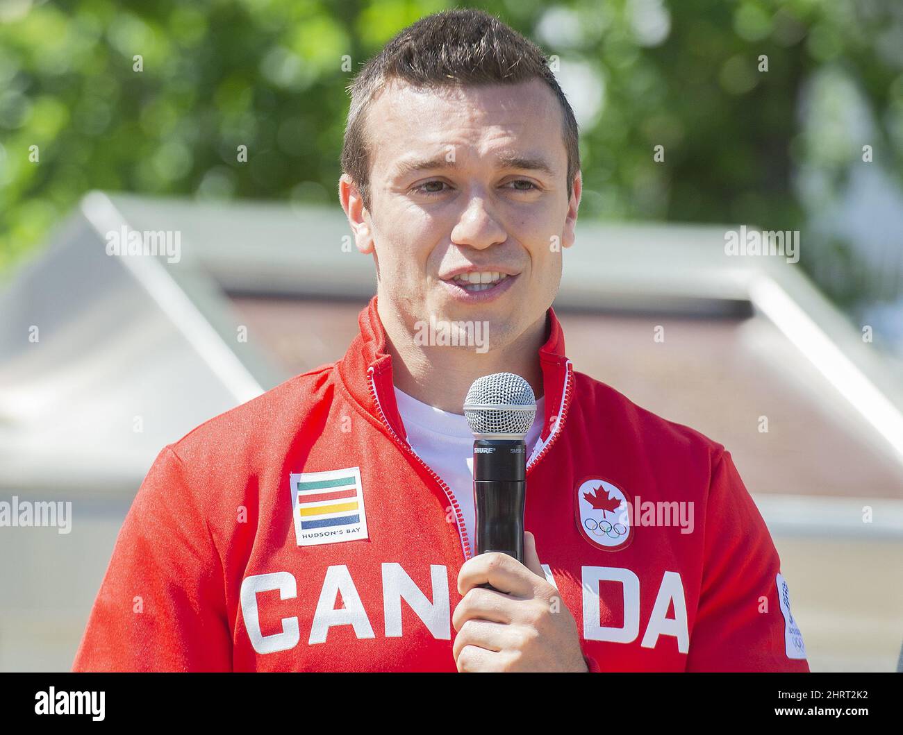 Gymnast Rene Cournoyer speaks to reporters after receiving his official ...