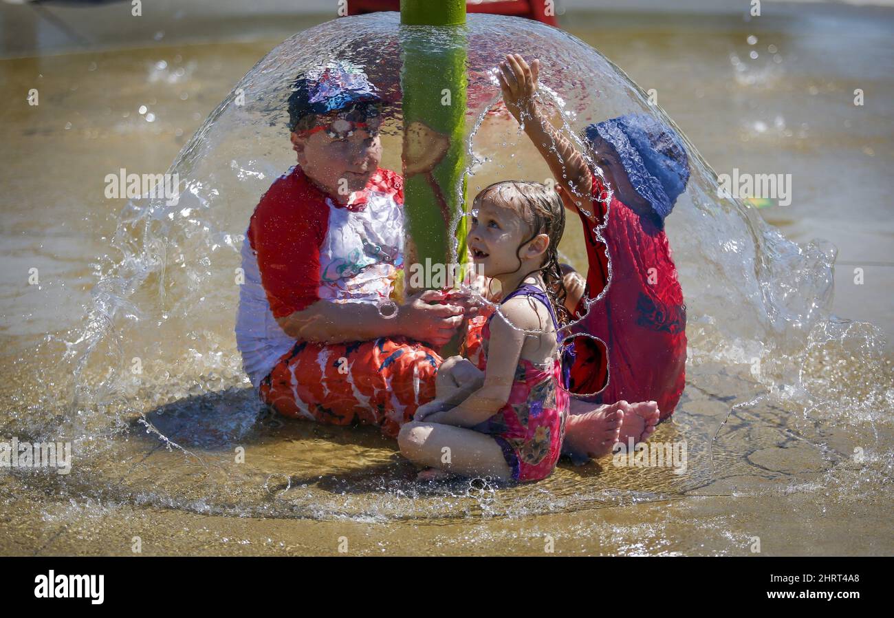 Poppy Collins, centre, five, and Leo Walkey, left, five, sits under a ...