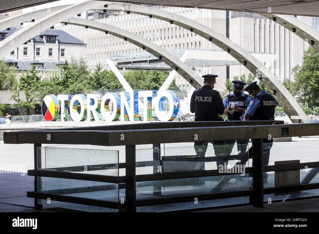 Toronto Police officers work the scene at Toronto City Hall's parking ...