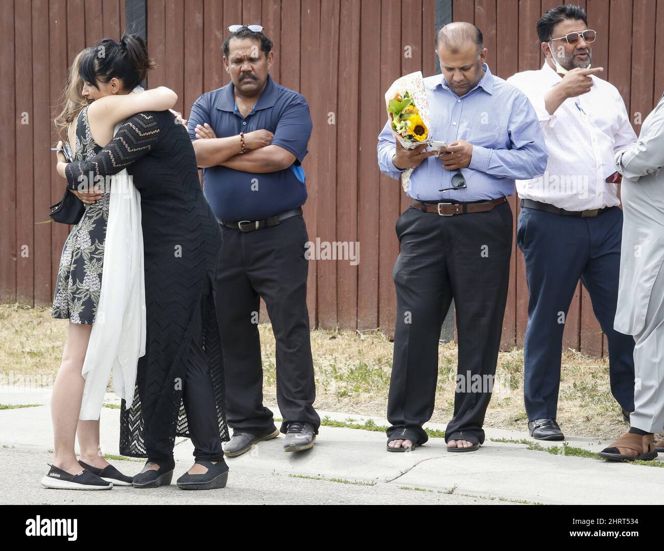 Mourners gather at the scene where seven people, including four ...
