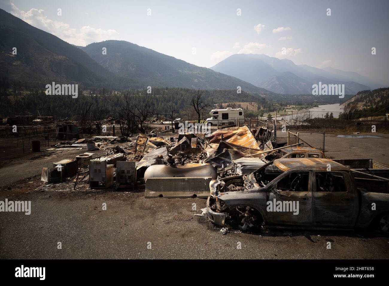 Damaged vehicles and a structure is seen in Lytton, B.C., on Friday ...
