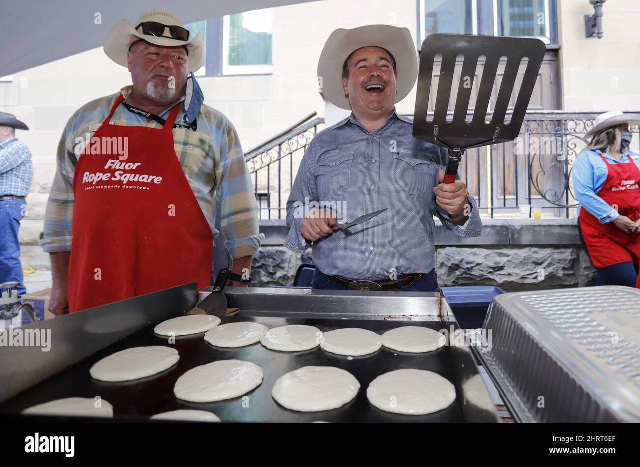 Alberta Premier Jason Kenney, right, laughs as he is handed an ...