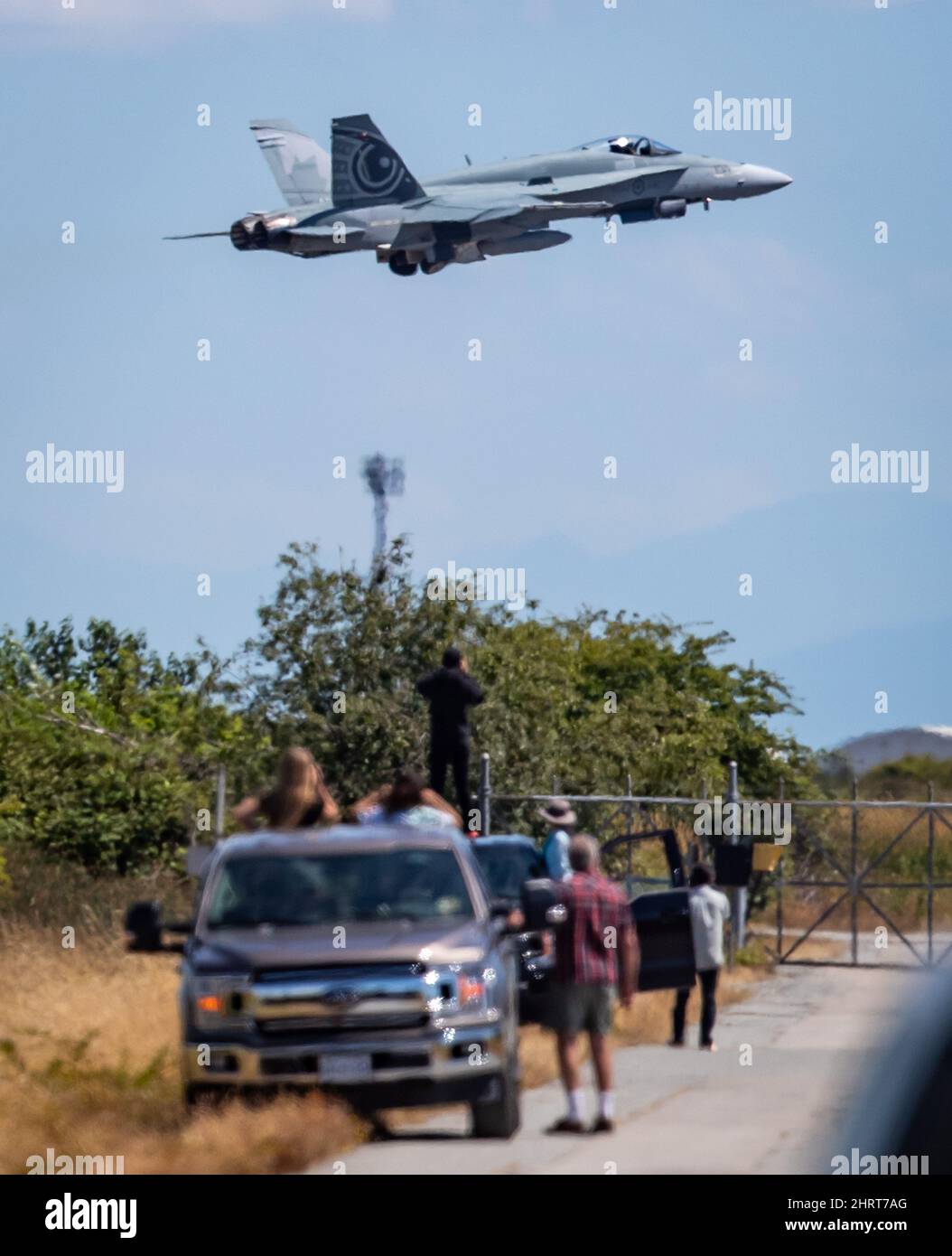 People watch as a Royal Canadian Air Force CF-18 Demonstration Team ...