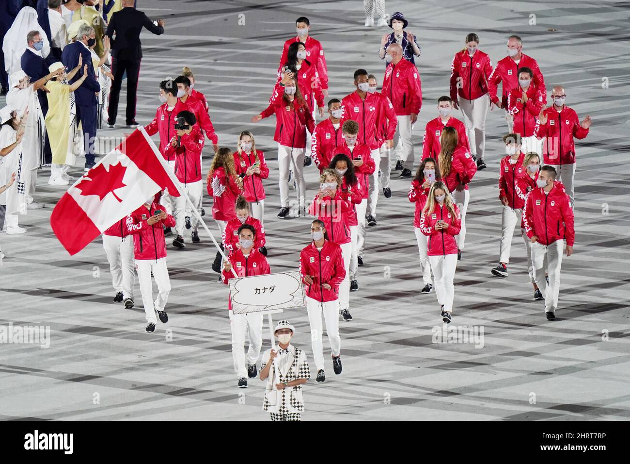 Team Canada flag-bearers Miranda Ayim and Nathan Hirayama carry the ...