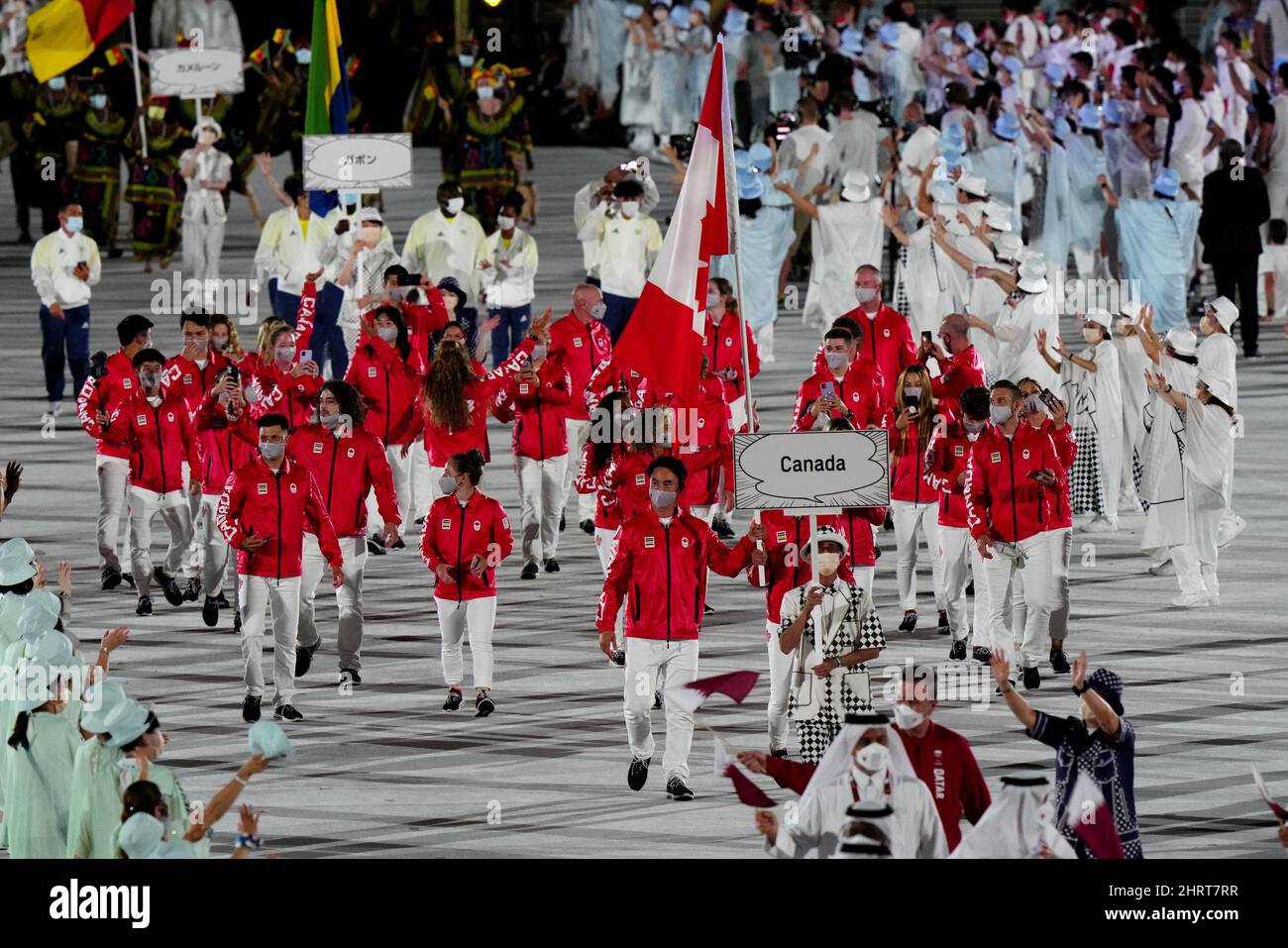 Team Canada flag-bearers Miranda Ayim and Nathan Hirayama carry the ...