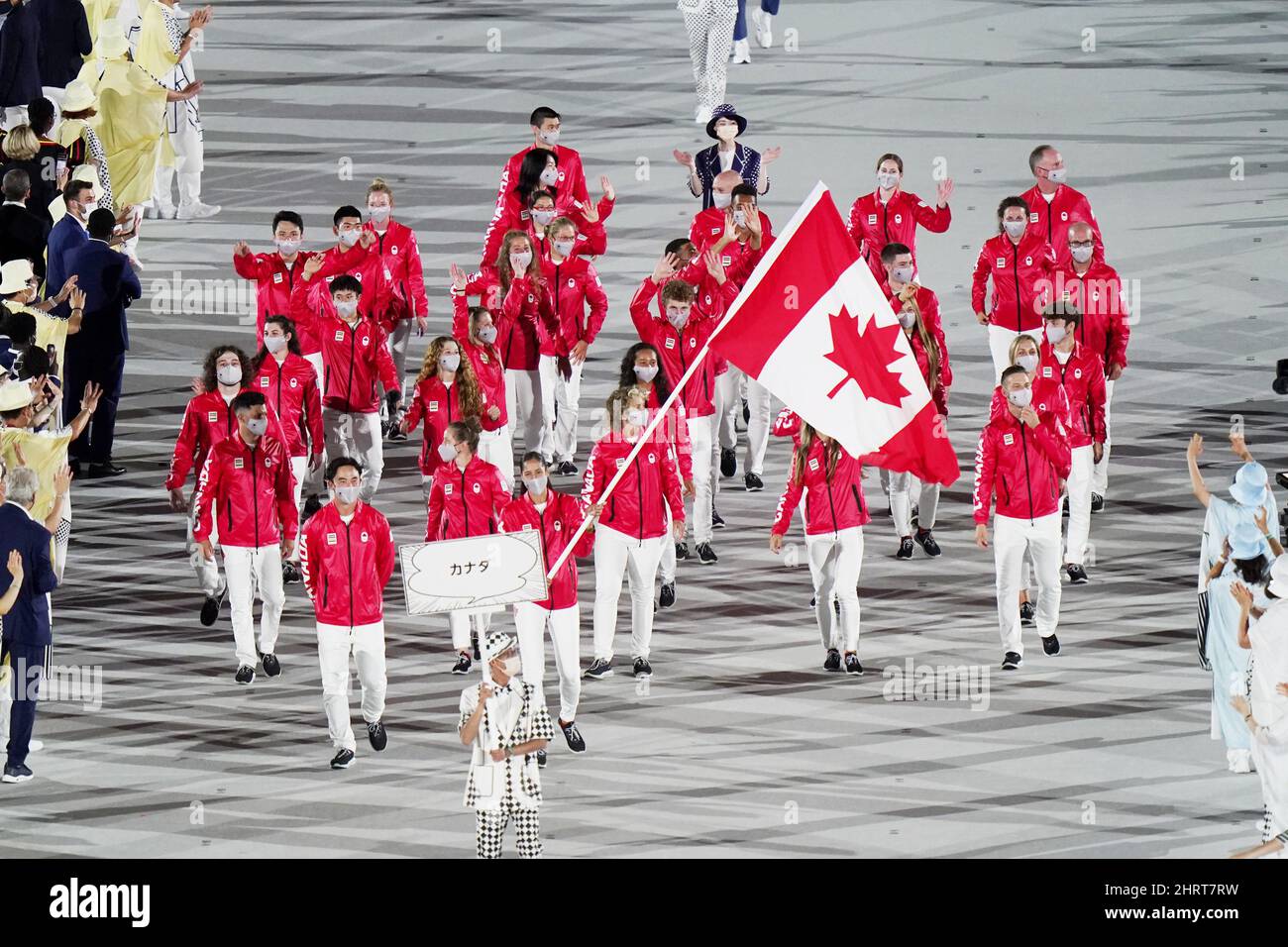 Team Canada flag-bearers Miranda Ayim and Nathan Hirayama carry the ...