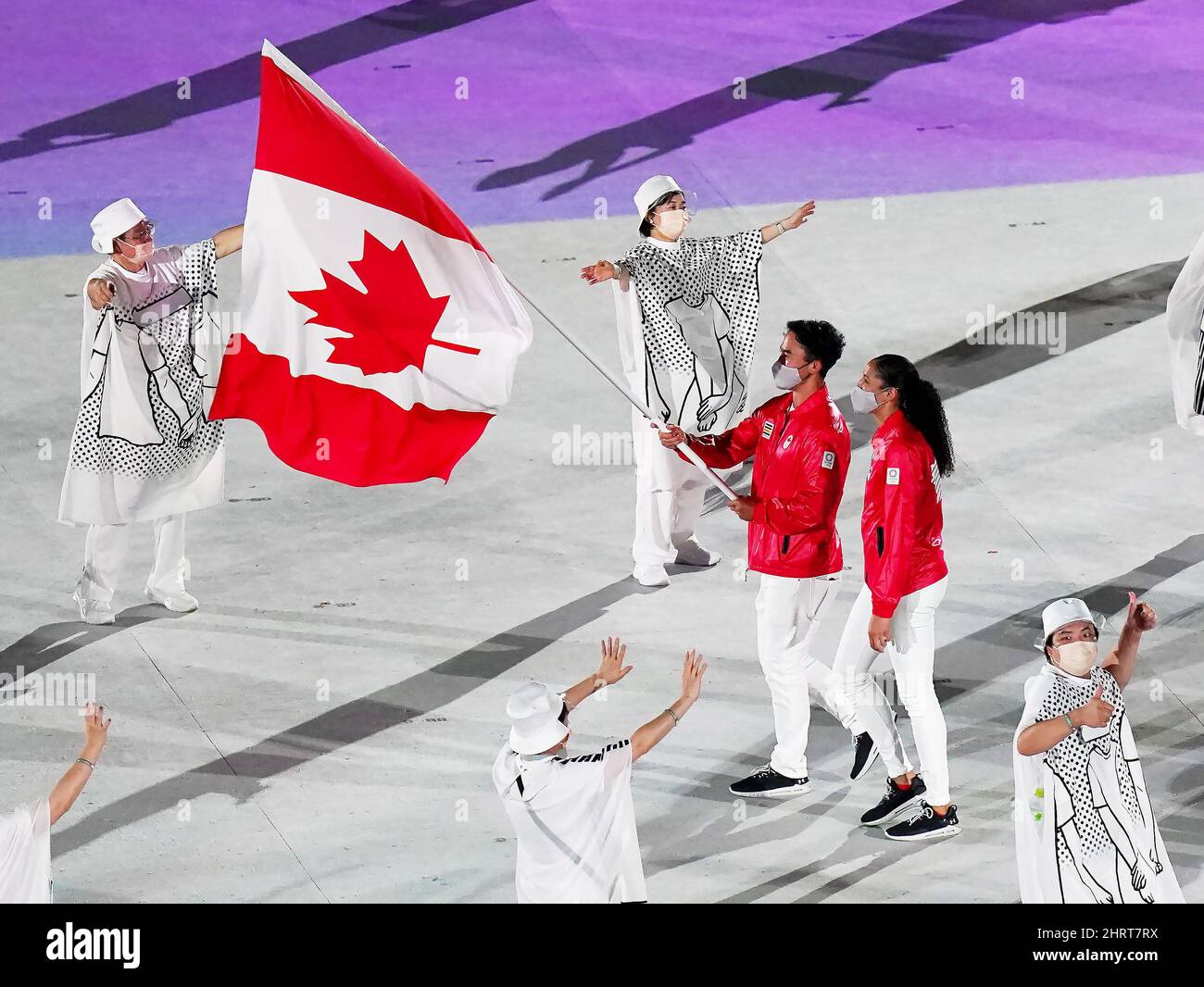 Team Canada flag-bearers Miranda Ayim and Nathan Hirayama carry the ...
