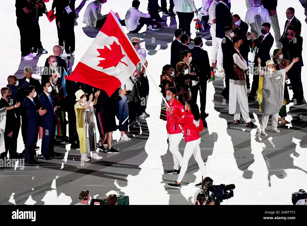 Team Canada flag-bearers Miranda Ayim and Nathan Hirayama carry the ...