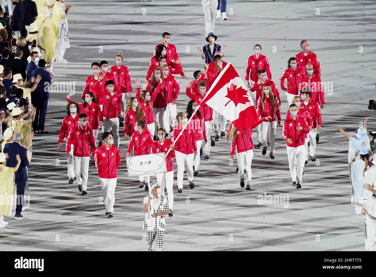 Team Canada flag-bearers Miranda Ayim and Nathan Hirayama carry the ...