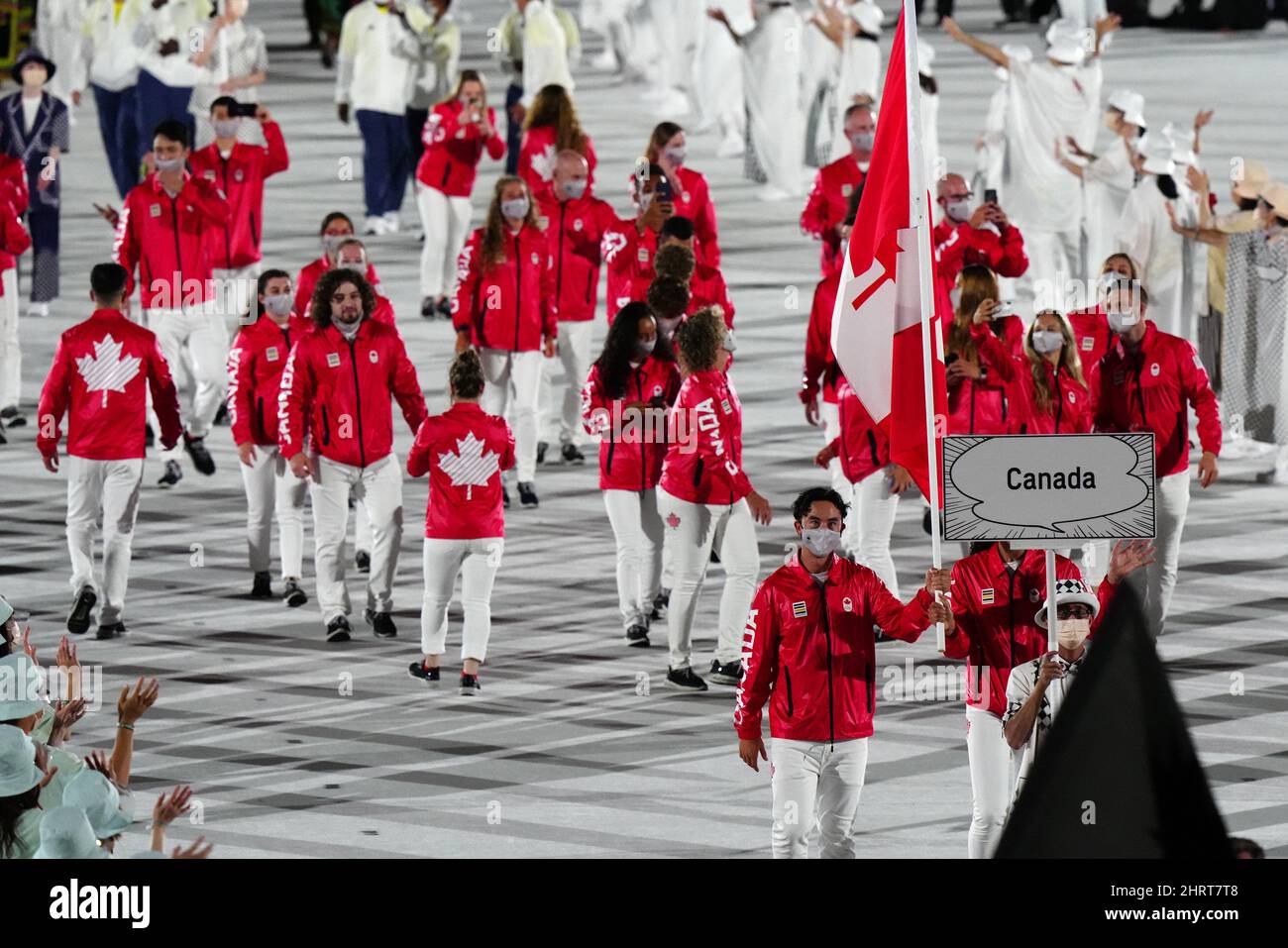 Team Canada flag-bearers Miranda Ayim and Nathan Hirayama carry the ...