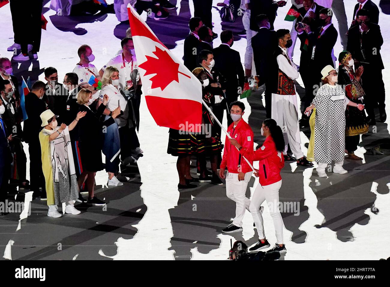 Team Canada flag-bearers Miranda Ayim and Nathan Hirayama carry the ...