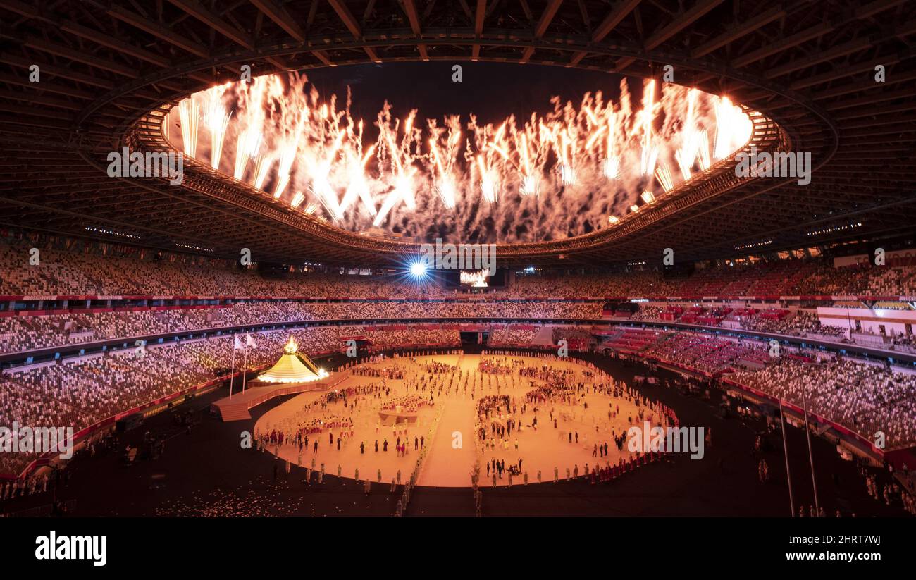 Fireworks illuminate the opening ceremonies as the Olympic flame is lit ...