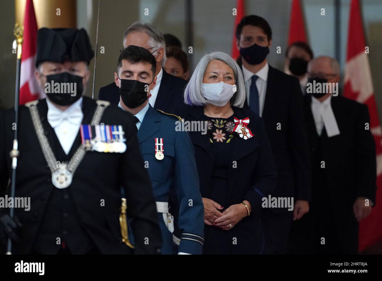 Governor General Mary Simon (centre) and a procession of dignitaries leave the Senate after she ...