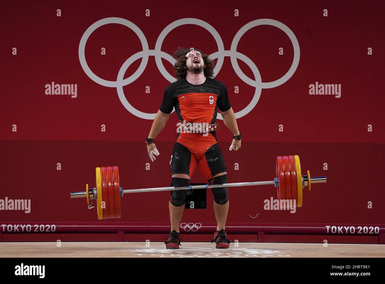 Boady Santavy of Canada reacts after lifting 208kg as he competes in ...
