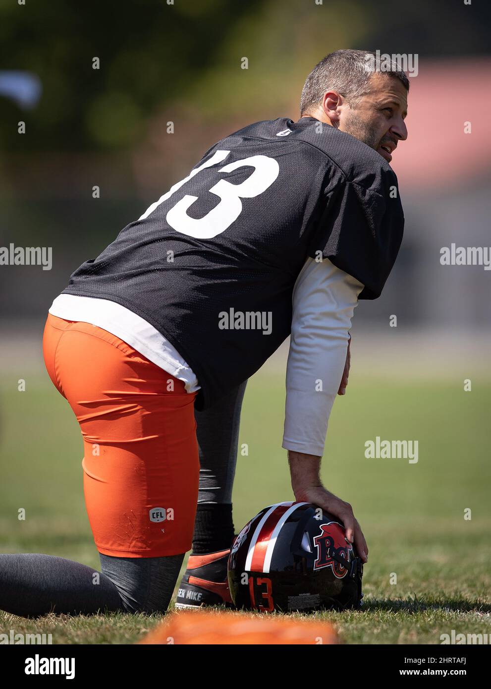 B.C. Lions quarterback Mike Reilly kneels on the sideline during ...