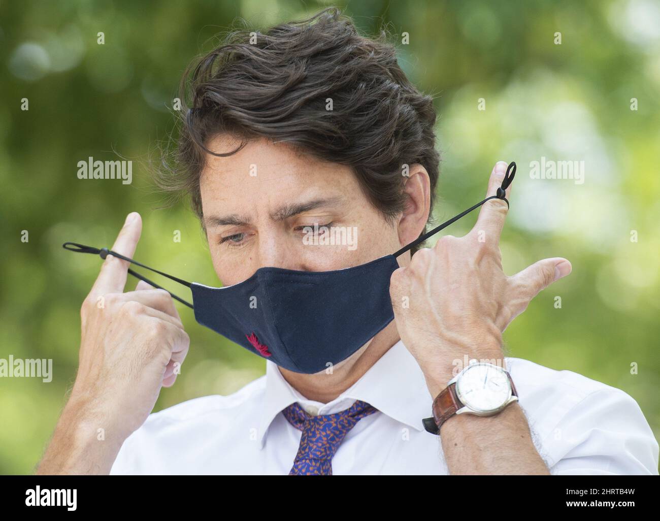 Prime Minister Justin Trudeau removes his mask during a childcare ...