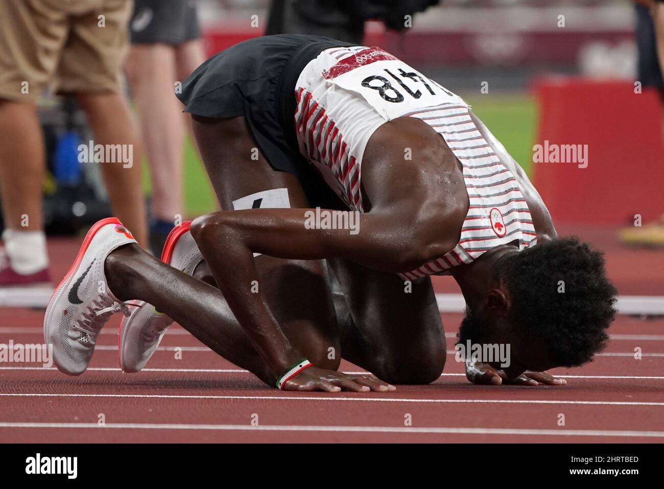 Canada's Moh Ahmed kisses the track after winning the silver medal in the men's 5000-metre final ...