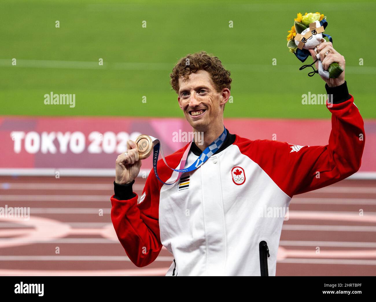 Evan Dunfee of Canada shows off his bronze medal for the menâ€™s 50km ...