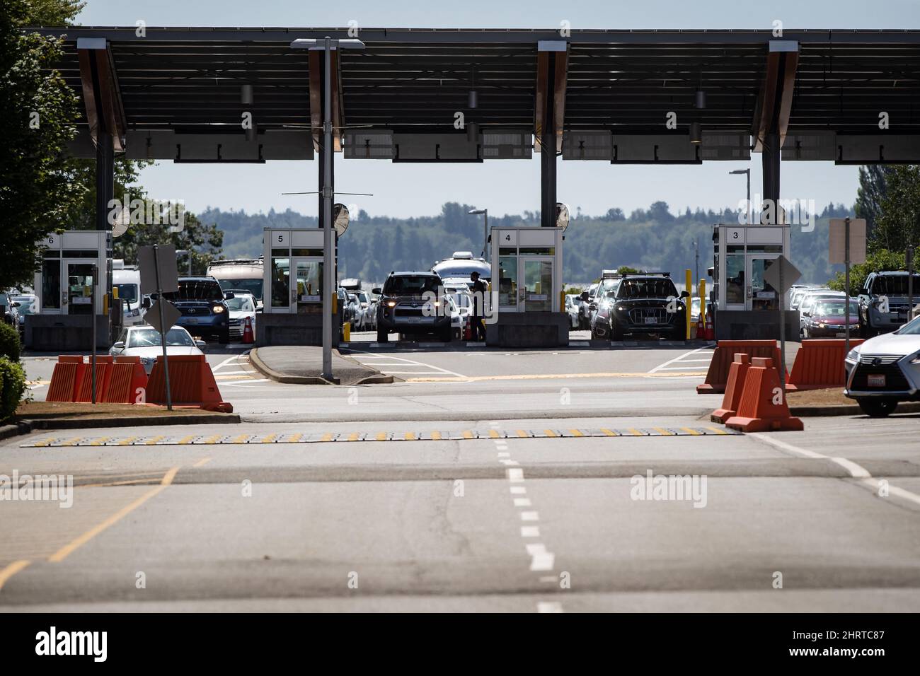 A Canada Border Services Agency officer is silhouetted as motorists ...
