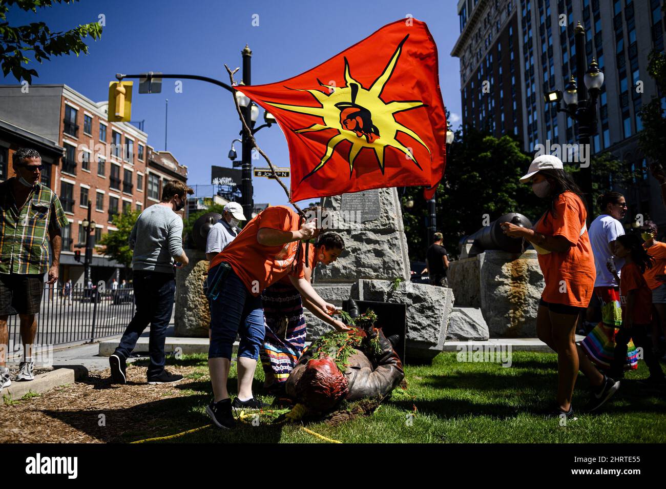 People place cedar sprigs on a statue of Sir John A. Macdonald which ...