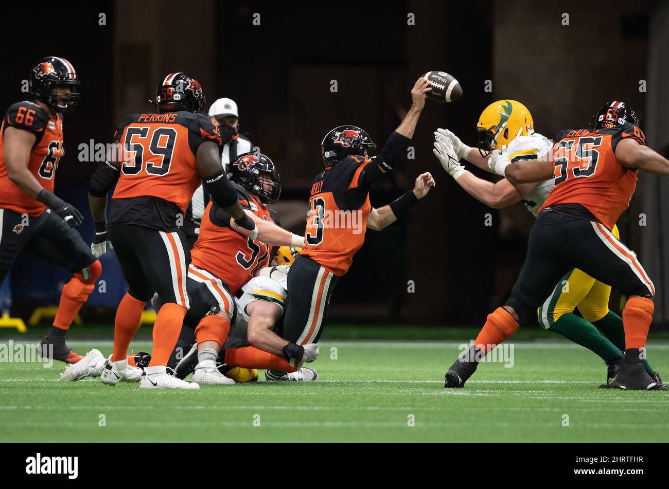 B.C. Lions quarterback Michael Reilly, centre, throws the ball away ...