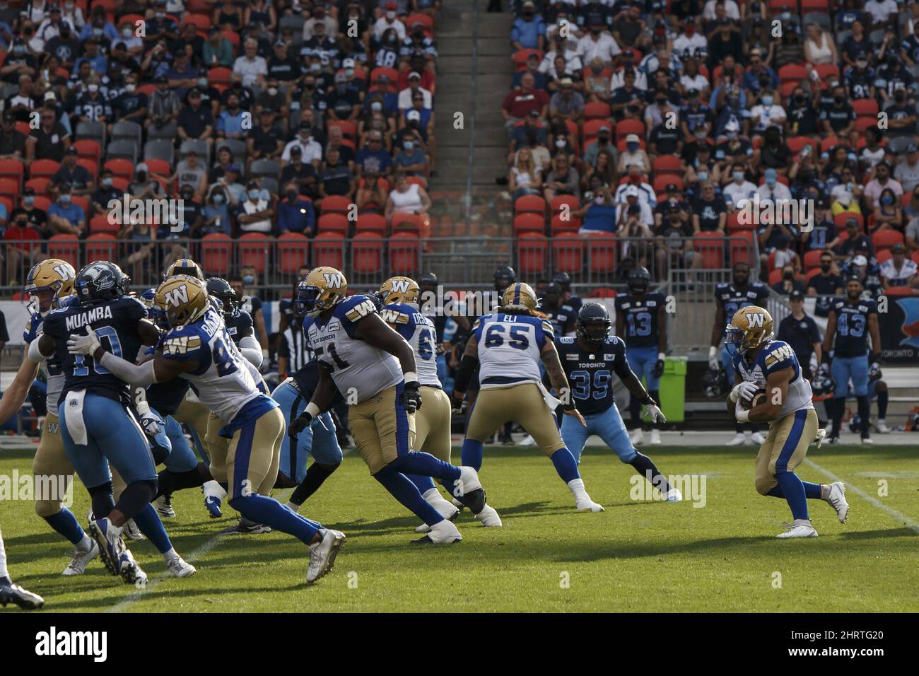 Winnipeg Blue Bombers running back Brady Oliveira (20) rushes with the ball in the second half ...