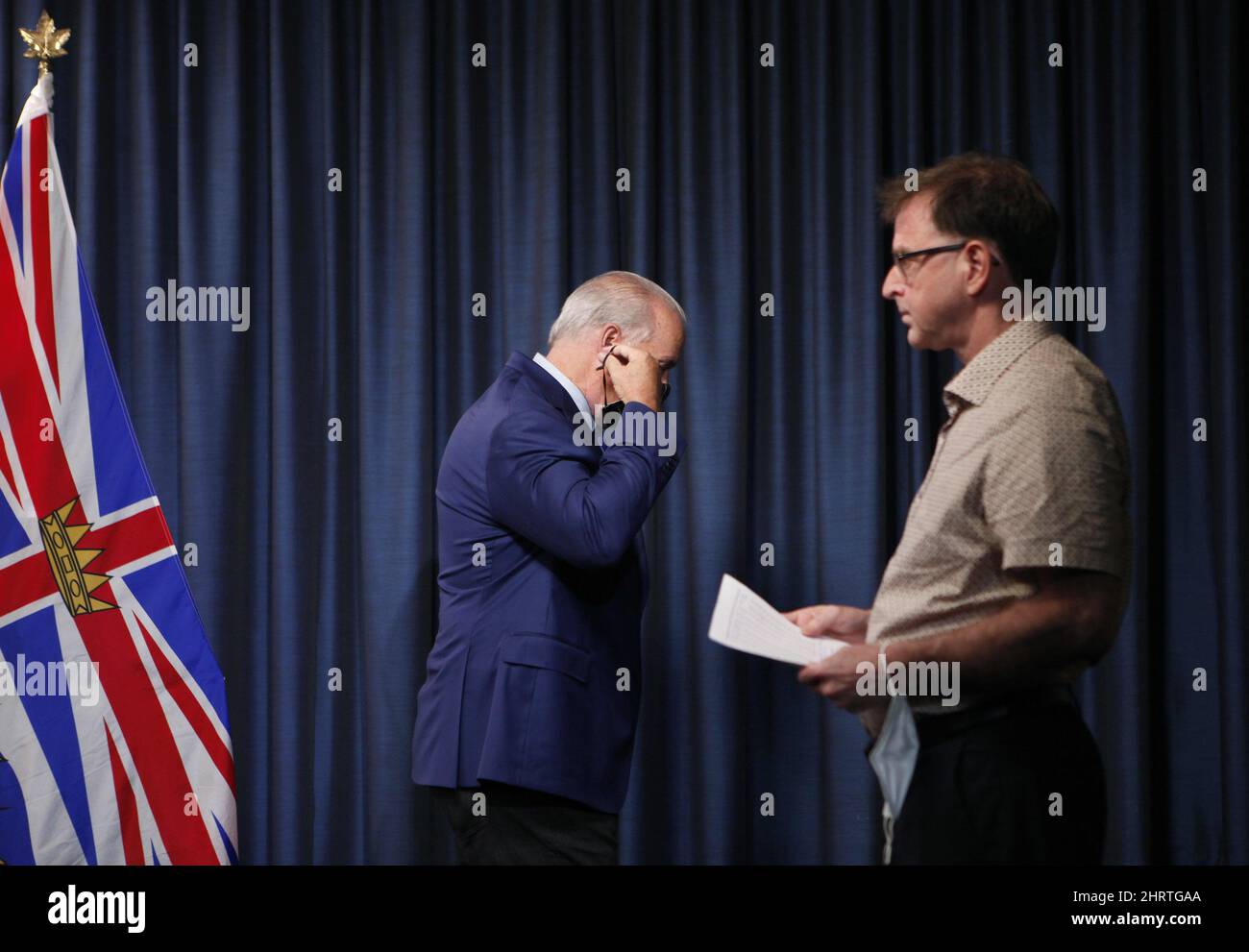 Premier John Horgan puts on his mask as Health Minister Adrian Dix ...