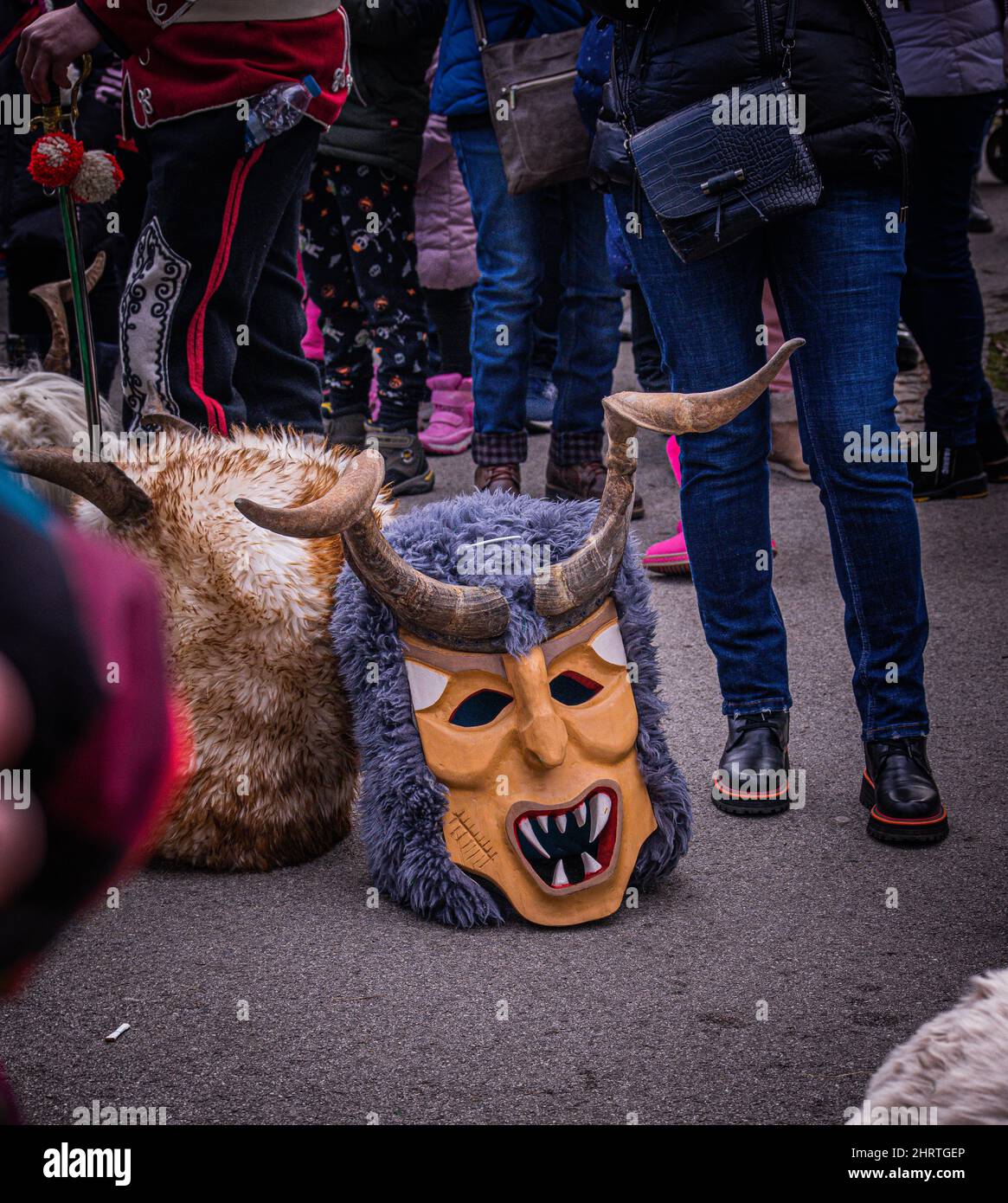 Traditional folk costumes and masks on the street at the Bulgarian ...