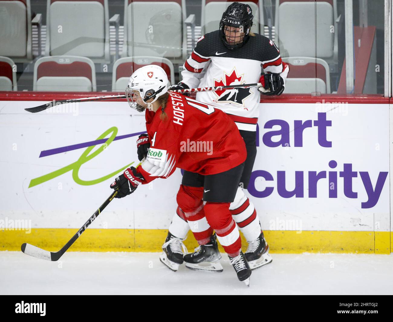 Switzerland's Nadine Hofstetter, left, checks Canada's Laura Stacey ...