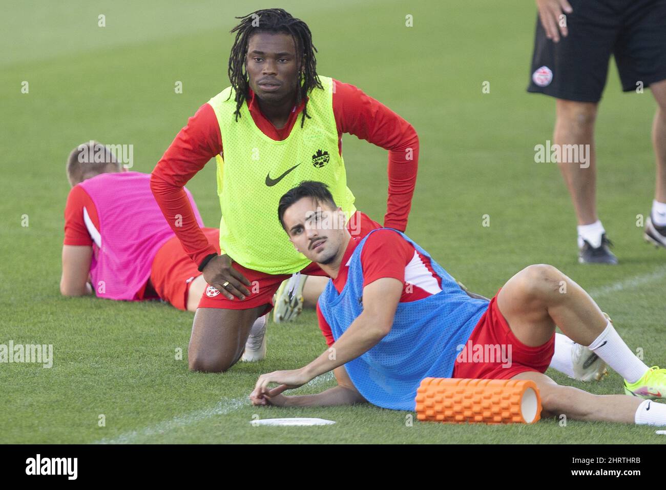 Sam Adekugbe (centre) stretches alongside Stephen Eustaquio (right) as ...
