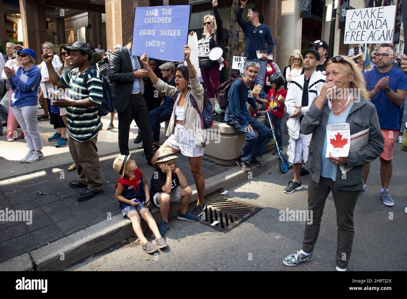 Protesters listen to a speaker as they gather outside Toronto Police ...