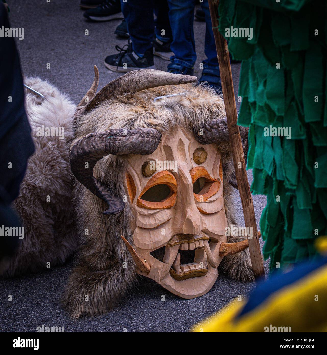 Traditional folk costumes and masks on the street at the Bulgarian ...