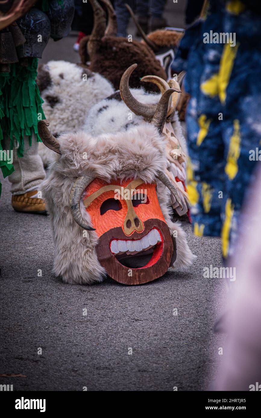 Traditional folk costumes and masks on the street at the Bulgarian ...