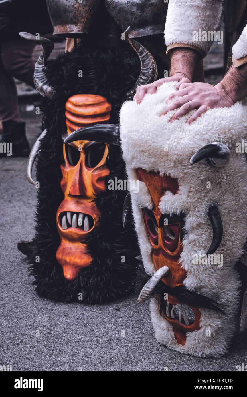 Traditional folk costumes and masks on the street at the Bulgarian ...