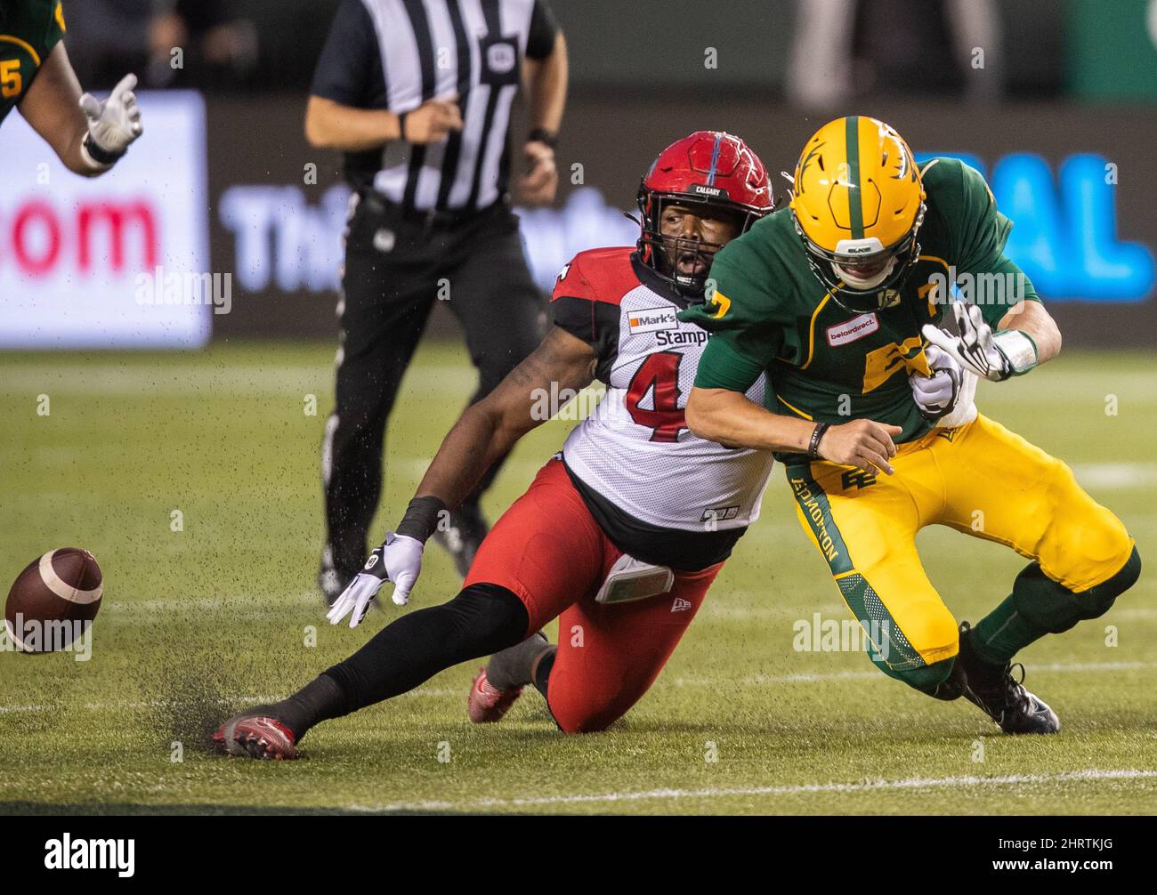 Calgary Stampeders' Shawn Lemon (40) tackles Edmonton Elks quarterback Trevor Harris (7) during ...