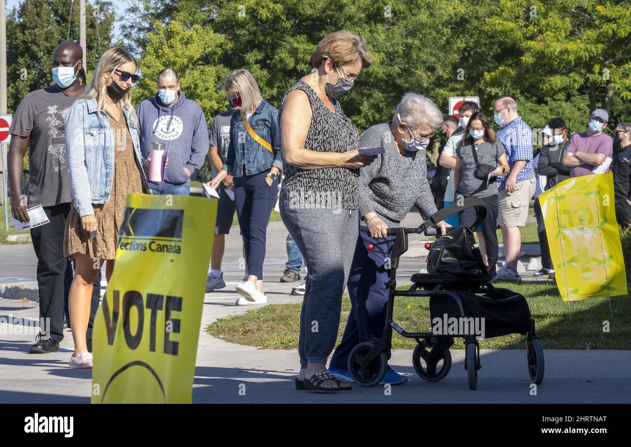 Voters line up at a polling station to vote in the Canadian federal ...