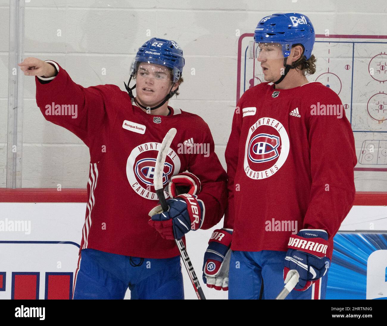 Montreal Canadiens Cole Caufield, left, goes over a play with Tyler ...