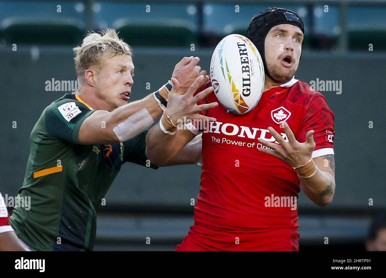 Canada's Jake Thiel, right, battles for the ball with South Africa's JC ...