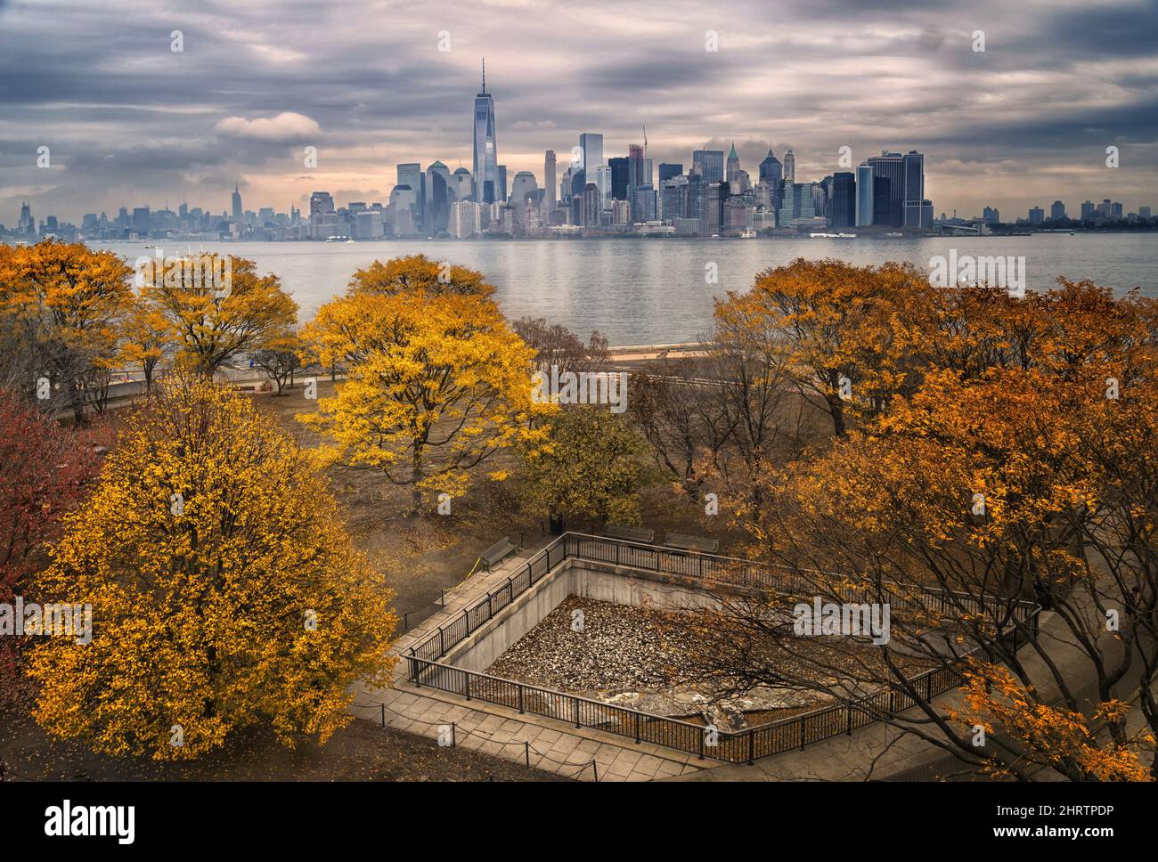 Mesmerizing view of Manhattan from Ellis Island under the cloudy sky ...