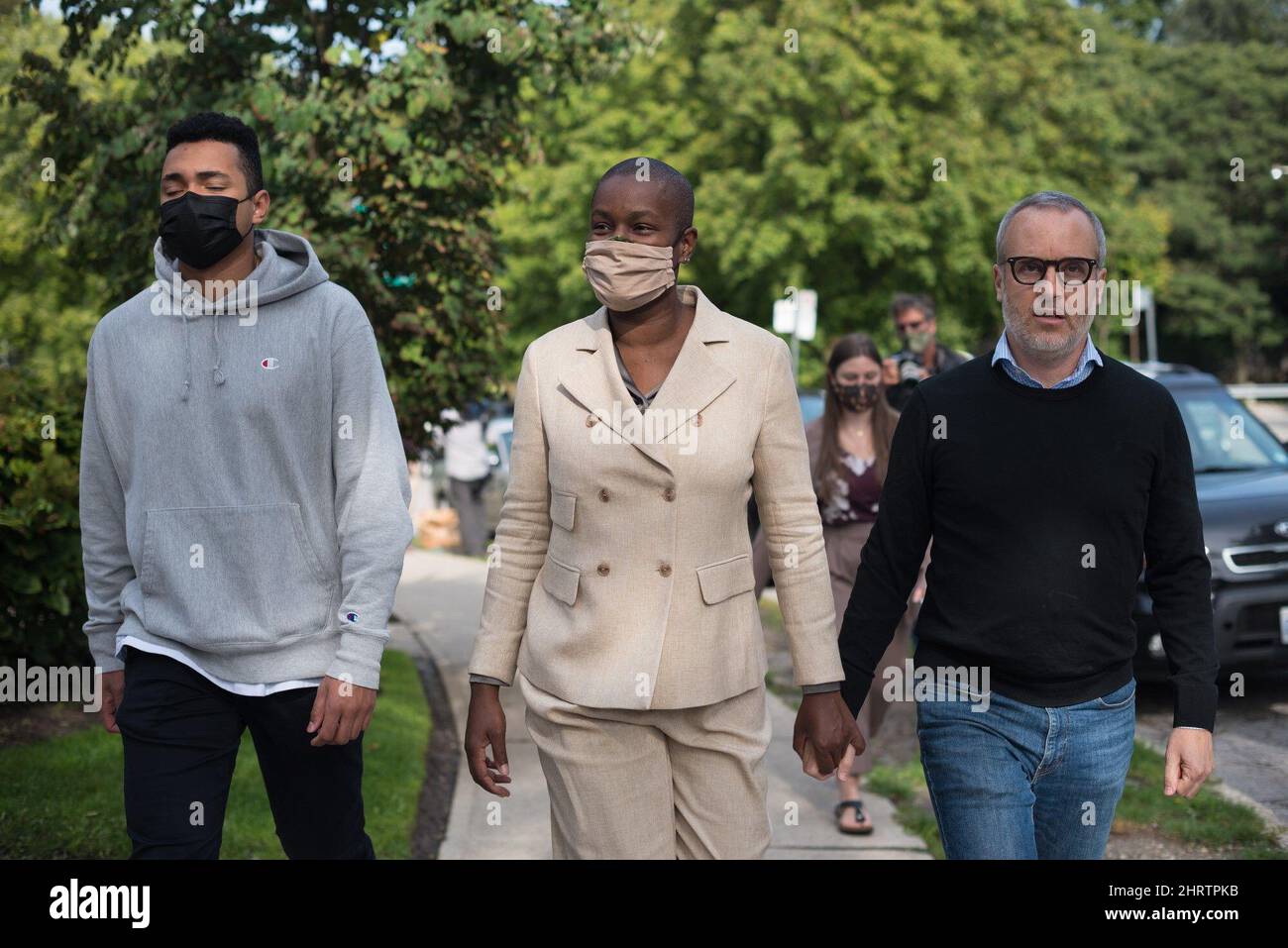 Annamie Paul holds hands with her husband, Mark Freeman, as they walk ...