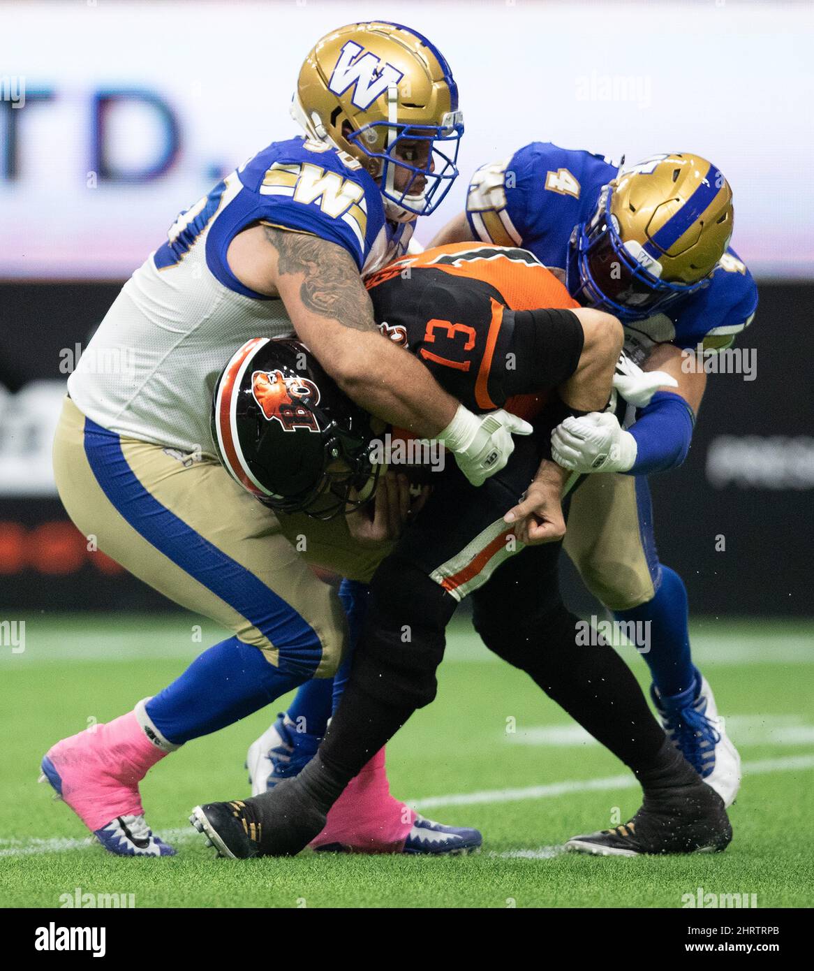 B.C. Lions quarterback Michael Reilly (13) is sacked by Winnipeg Blue ...