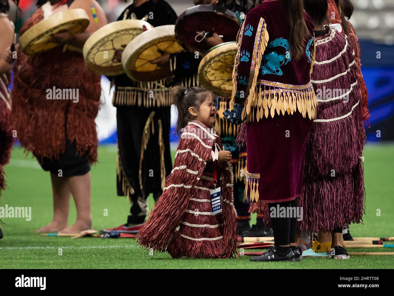 A young child cries after falling while dancing as members of Tsatsu ...