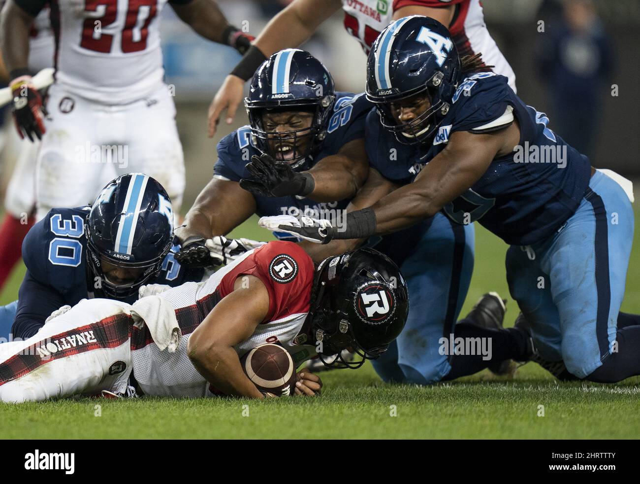 Ottawa Redblacks quarterback Caleb Evans (5) gets tackled by Toronto ...