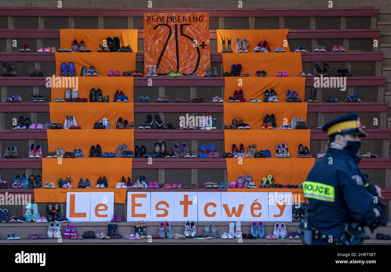 A member of the RCMP walk past a memorial set up at TkÃ•emlups the ...