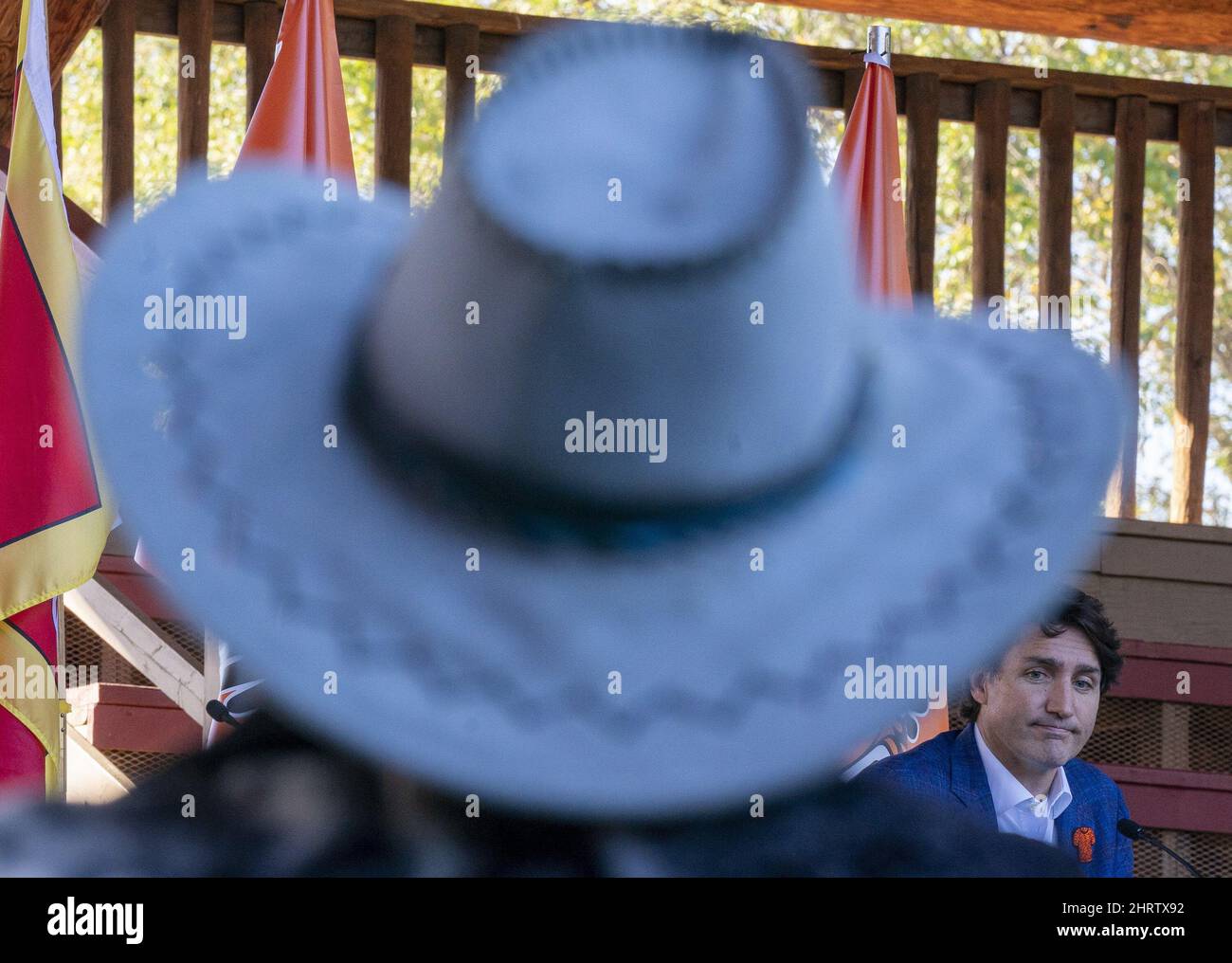 Prime Minister Justin Trudeau is framed by a hat worn by a elder as he ...