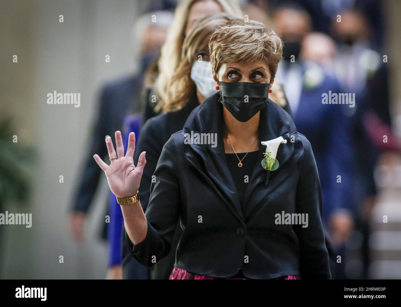 Jyoti Gondek waves to family as she enters council chambers to be sworn ...