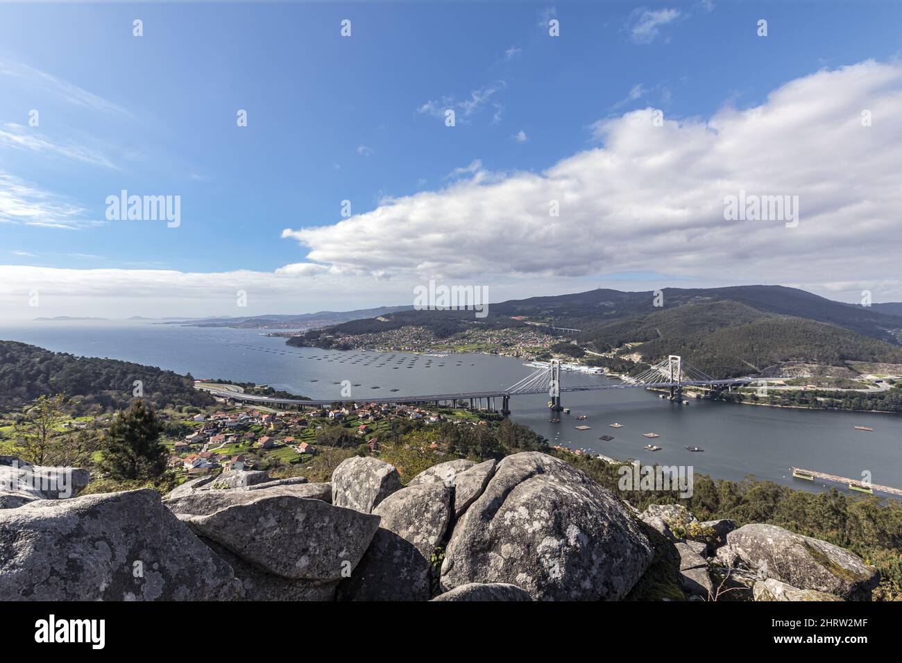 Bridge going through the sea with green trees under a blue Stock Photo ...