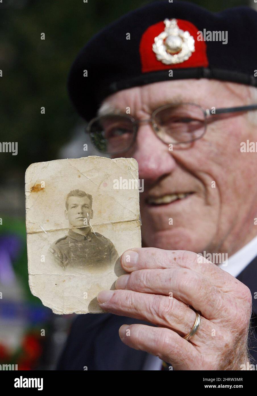 WW II veteran James Revely, 85, holds a photo of his father James ...
