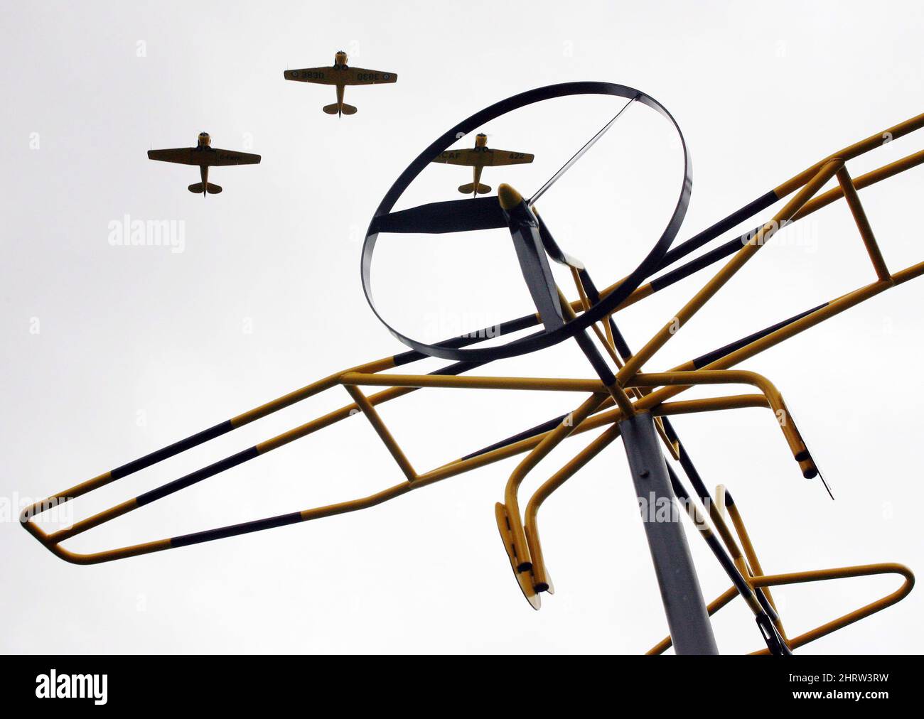 Vintage Harvard aircraft perform a fly-past over a silhouette scale ...